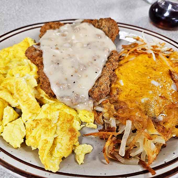 Chicken fried steak with gravy that cascades like a waterfall of comfort. The scrambled eggs and hash browns are just supporting actors in this drama.