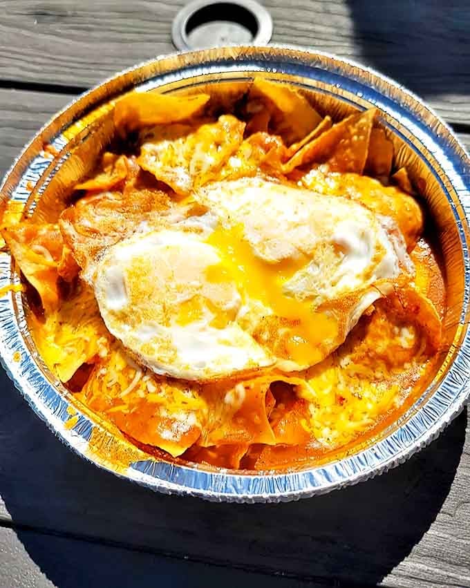 Chilaquiles: where tortilla chips go to be reborn in a pool of salsa, crowned with a perfectly fried egg that's just waiting for its Instagram moment.