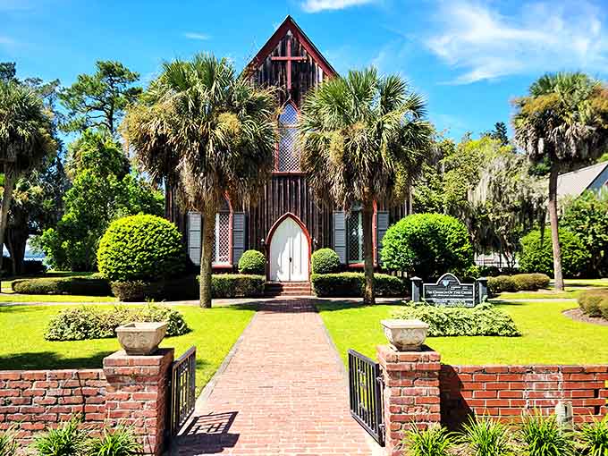 The Church of the Cross stands as Bluffton's Gothic heartbeat, where crimson walls and palm sentinels have witnessed over 160 years of prayers and promises.