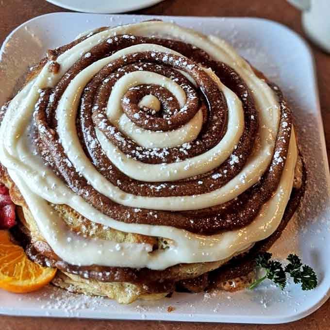 These cinnamon swirl pancakes aren't just breakfast&mdash;they're an architectural achievement with frosting that would make a pastry chef weep.