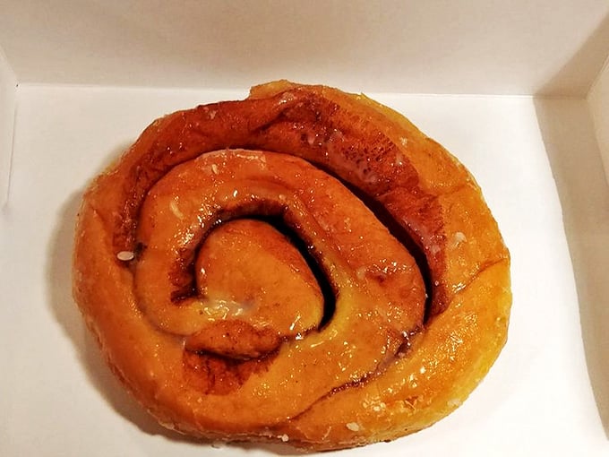 The cinnamon roll spirals hypnotically, as if trying to convince you that calories consumed in pursuit of happiness don't count.