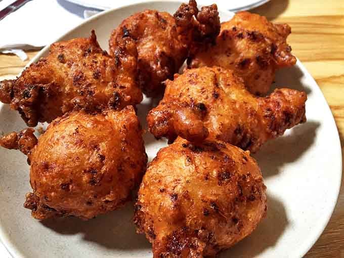 Golden-brown clam cakes looking like edible beach treasures. Crispy outside, fluffy inside&mdash;the way Neptune intended.