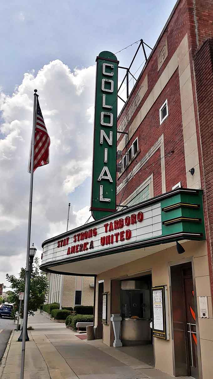 The Colonial Theatre's vertical sign stands tall against Carolina blue skies. Classic Americana that makes you want to buy a ticket just for the nostalgia.