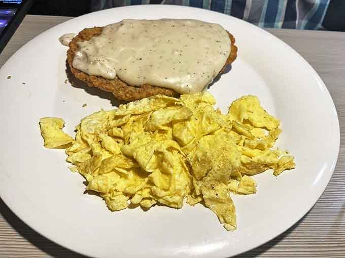 Country-fried steak that's crispy outside, tender inside, and absolutely swimming in creamy gravy&mdash;paired with eggs scrambled to golden perfection.