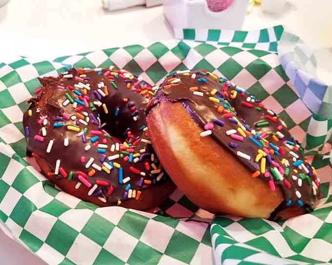 Chocolate donuts with rainbow sprinkles: proof that happiness can be purchased for the price of dessert.