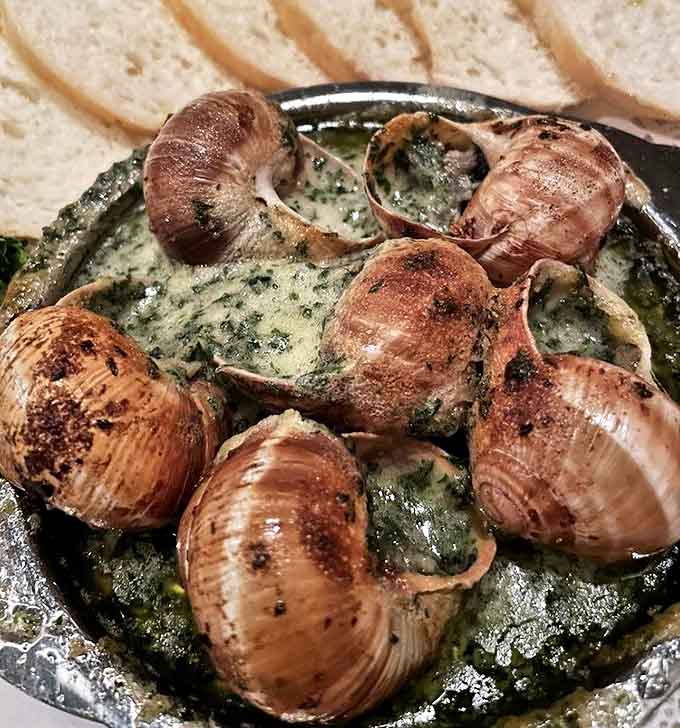 Escargot that would make Julia Child nod in approval&mdash;swimming in garlic butter that demands every last bit of bread for sopping.