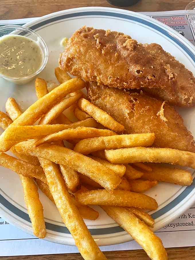 Golden-battered fish that would make Neptune himself swim upstream. Paired with those fries, it's a plate of crispy perfection.