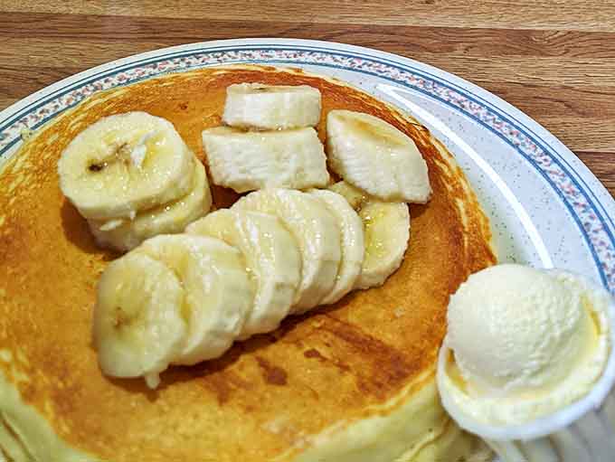 Golden pancakes topped with fresh banana slices—proof that sometimes the simplest pleasures are the most satisfying.