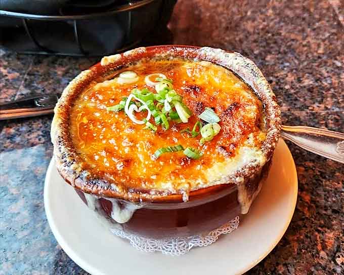 French onion soup that's worth the cheese pull photo op&mdash;a bubbling cauldron of comfort topped with a golden crown.