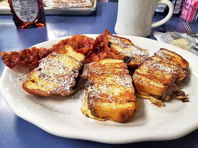 French toast that's achieved that magical balance of crispy exterior and custardy interior, dusted with powdered sugar and served with a side of nostalgia.