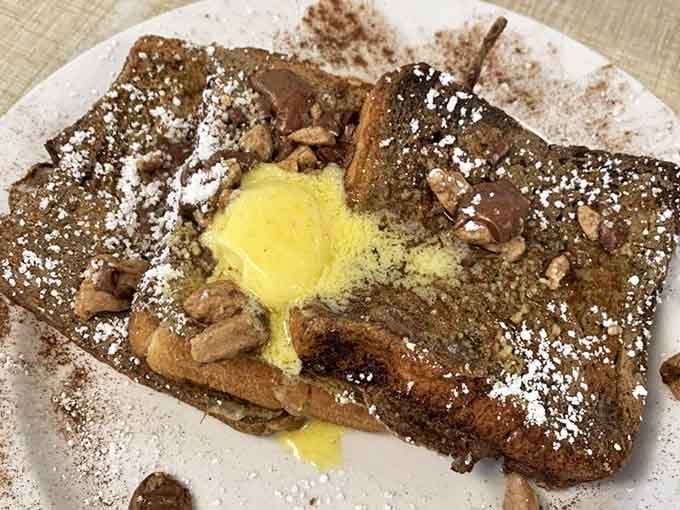 French toast that's crossed the line from breakfast to dessert and isn't apologizing for it. That butter pat melting on top is performing a slow dance of deliciousness.