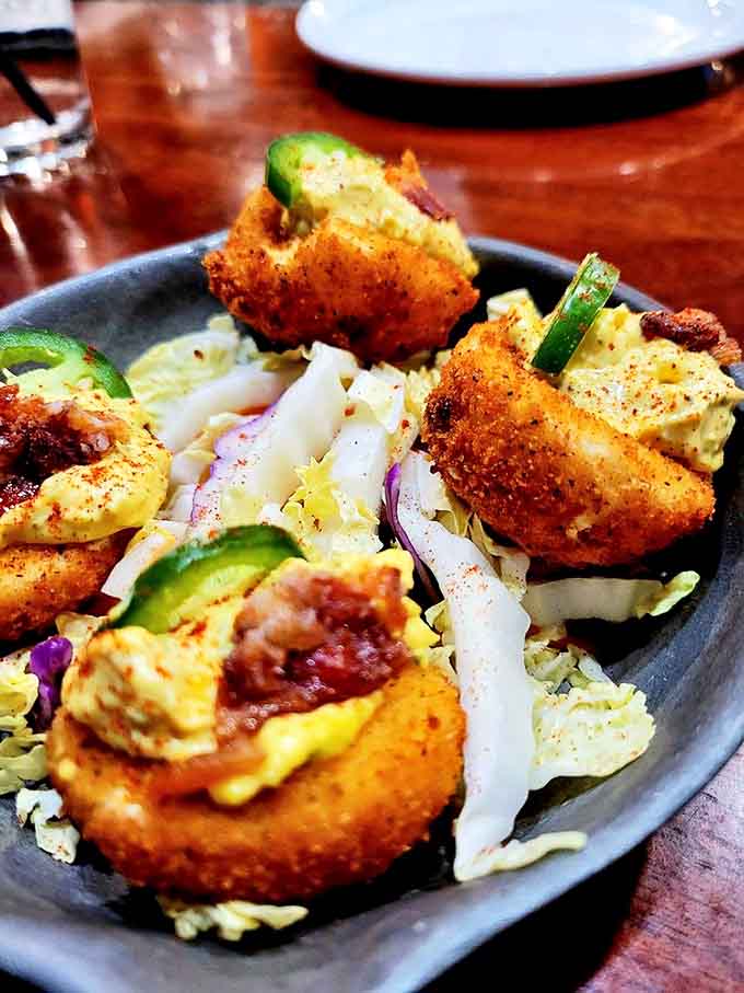 Deviled eggs get the royal treatment &ndash; crispy, creamy, and served on a bed of slaw that adds the perfect crunch.