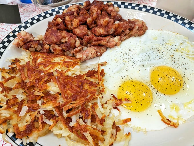 The breakfast trinity: golden hash browns, sunny-side-up eggs, and corned beef hash &ndash; a holy alliance that makes mornings worth facing.
