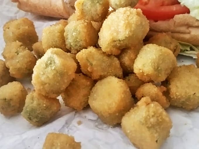 These golden-fried hush puppies aren't just side dishes; they're little spheres of cornmeal joy waiting to be devoured.