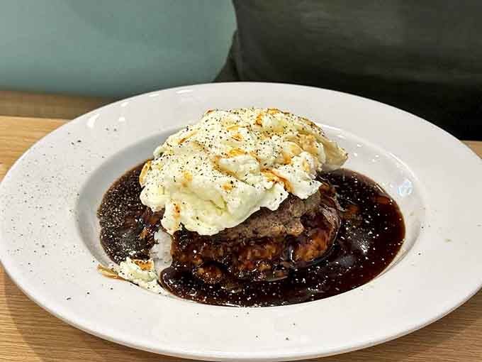 The legendary loco moco in its natural habitat &ndash; a hamburger patty swimming in gravy with an egg hat that's ready for its close-up.