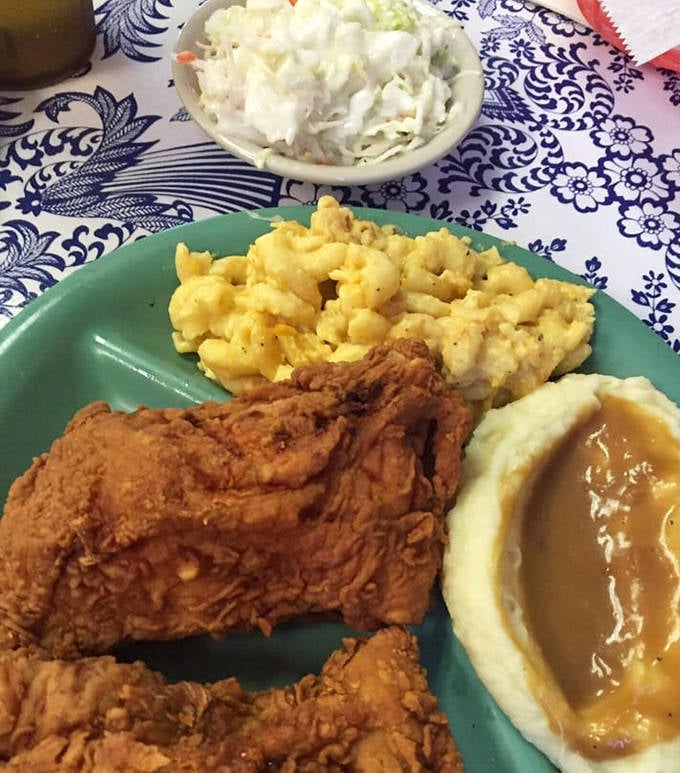 Southern math at its finest: one perfect piece of fried chicken plus three country sides equals heaven on a turquoise plate.