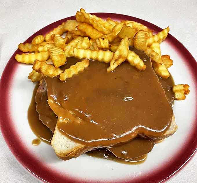 The hot open-faced sandwich – where gravy isn't just an option, it's the star. Crispy fries standing by for the inevitable delicious gravy overflow.