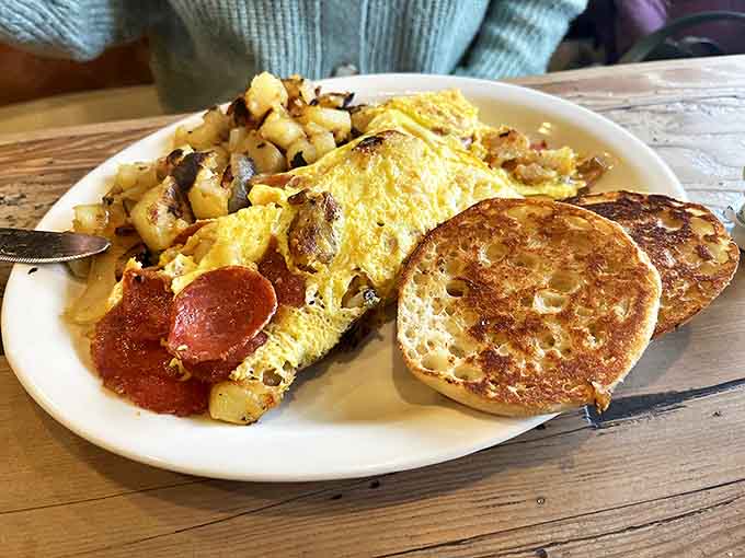 This omelet doesn't just sit on the plate&mdash;it commands attention. Paired with those golden-brown home fries and English muffins, it's the breakfast equivalent of a standing ovation.