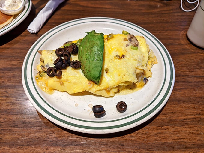 This omelet doesn't just have fillings&mdash;it has ambitions, complete with a slice of avocado standing guard like a green sentinel.