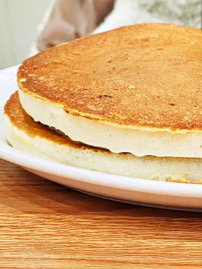 Pancakes that achieve the perfect golden hue &ndash; fluffy islands ready for maple syrup rivers to transform them into breakfast paradise.