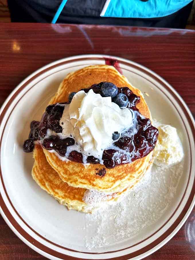 Blueberry pancakes that don't just whisper their namesake&mdash;they sing it proudly with fresh berries and enough whipped cream to make Monday bearable.