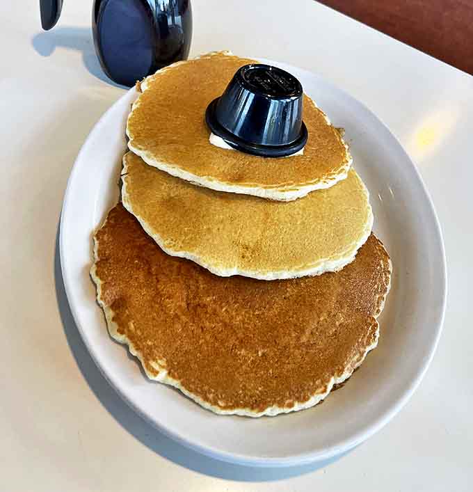 Stack attack! These golden pancakes aren't just breakfast—they're an engineering marvel of fluffy perfection waiting for syrup.