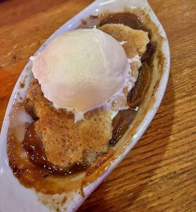 Cobbler that tastes like summer memories. The vanilla ice cream performs its beautiful melting dance atop warm fruit and buttery crust&mdash;a timeless dessert duet.