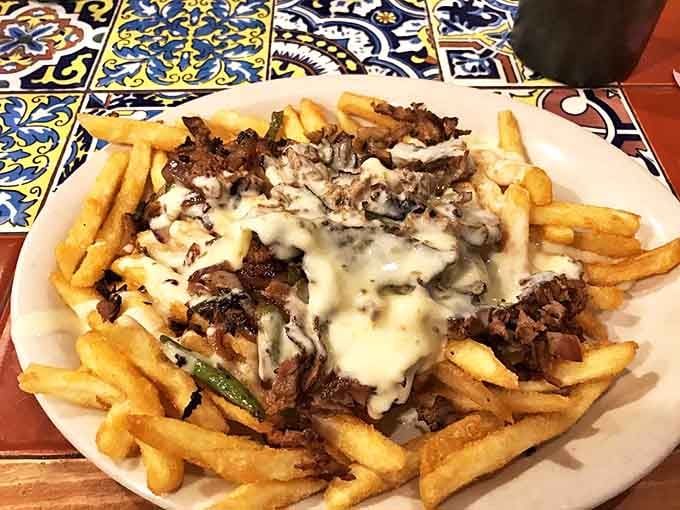 Philly cheesesteak fries: where the concept of "sharing" goes to die. A mountain of crispy potatoes topped with tender beef and a blanket of melted cheese.