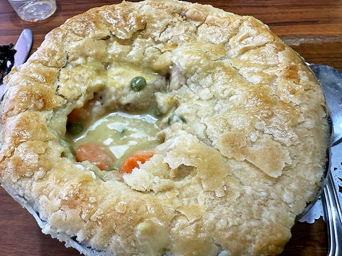 This pot pie isn't just comfort food, it's a warm hug in pastry form. Look at that golden crust practically bursting with savory filling!
