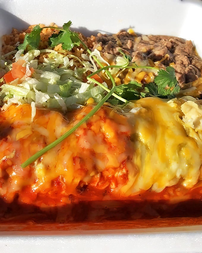 The holy grail of New Mexican cuisine: red and green chile smothering a burrito with such perfect melty cheese it should have its own Instagram account.