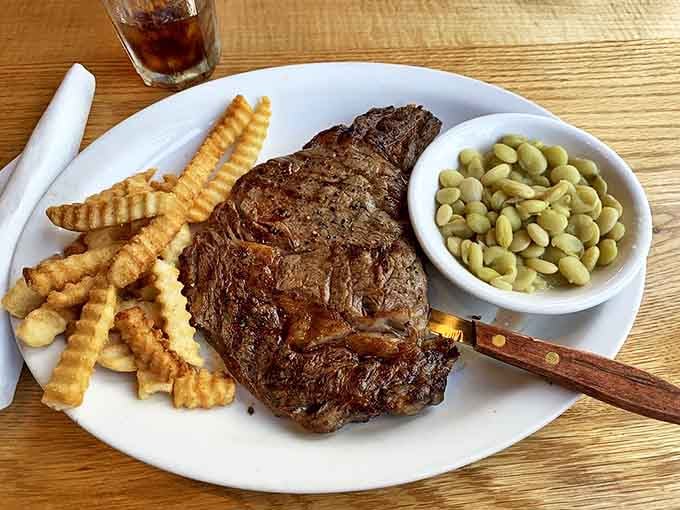 A ribeye that would make Ron Swanson weep tears of joy, paired with crinkle-cut fries that transport you straight back to childhood.