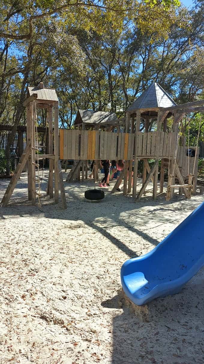 The children's playground blends seamlessly with nature, offering little ones a wooden wonderland for adventure while parents enjoy a moment's peace.
