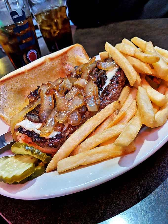 A burger's sophisticated cousin &ndash; tender steak smothered in caramelized onions with perfectly golden fries standing at attention alongside.