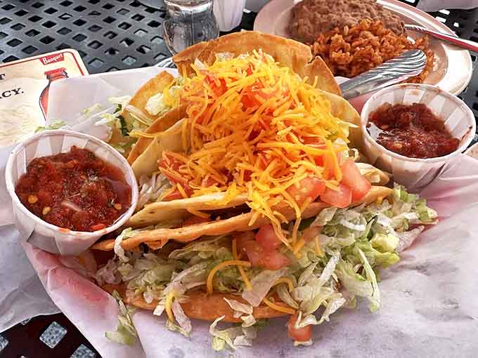 These tacos arrive with enough shredded cheese to make Wisconsin jealous and sides of salsa for good measure.