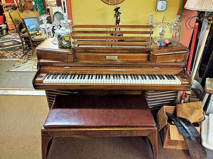 A vintage piano waits silently at Golden Girls, its polished wood and ivory keys ready to play melodies from another era.