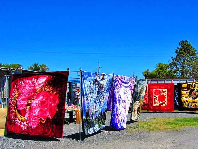 Textile treasures flap gently in the breeze, each blanket telling stories of faraway places while promising cozy nights at home.