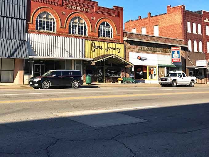 The historic Citizens Bank building stands proudly above newer storefronts, a architectural reminder that some investments truly stand the test of time.