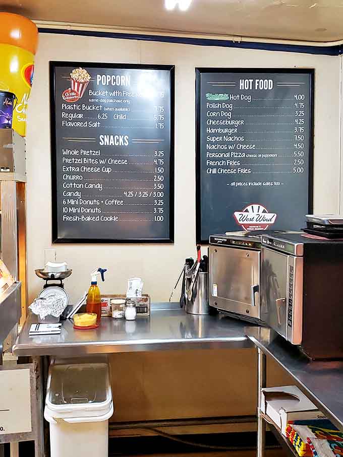 The menu board reads like a time capsule of American movie-watching traditions. Popcorn buckets with free refills? Now that's entertainment!