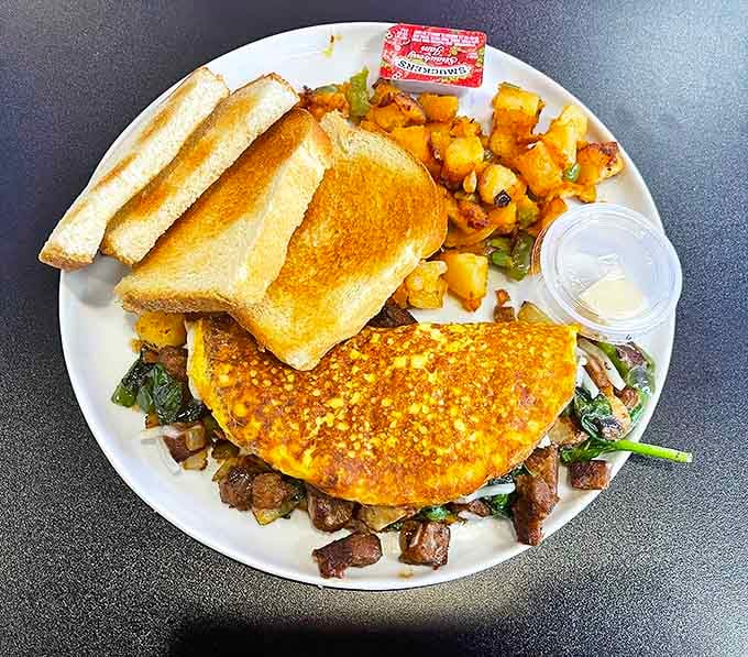 An omelet that's having a serious identity crisis&mdash;part breakfast, part steakhouse dinner, all delicious with those golden home fries.