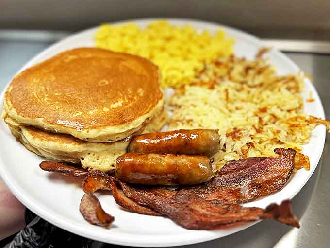 Pancakes golden as South Dakota sunrise, with bacon and sausage standing at attention. This is breakfast with purpose.