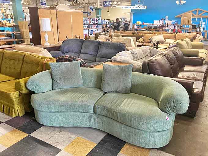 Sofa kingdom! That mint green curved number looks like it was teleported straight from a 1960s James Bond villain's lair.