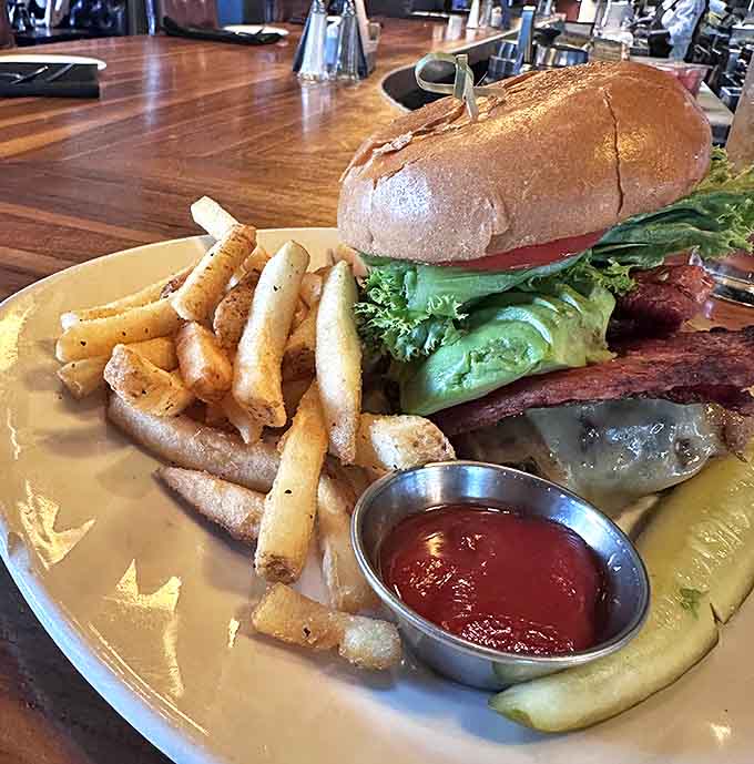 The infamous Wagyu burger – where beef transcends mere sandwich status to become a religious experience, complete with perfect golden fries as disciples.