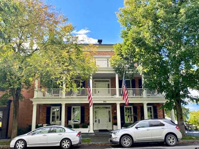 Aurora's historic inn stands proudly with American flags announcing "yes, we're exactly as charming as we look."