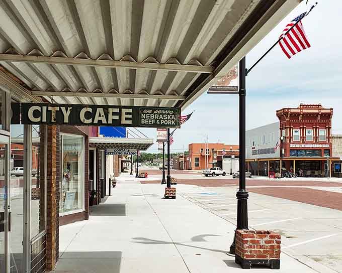 The City Cafe sign beckons hungry travelers to experience small-town hospitality under a shaded sidewalk canopy.