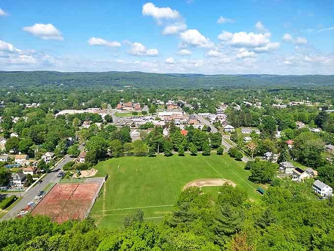 Greenfield spreads out beneath a perfect blue sky – a patchwork quilt of homes, fields, and possibilities.