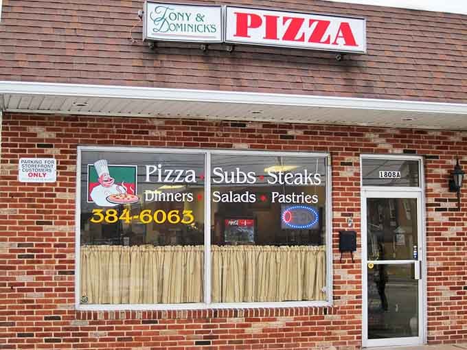 Tony and Dominick's classic brick storefront has that "been here forever" quality that promises authentic pizza experience. Those curtains hint at old-school charm inside.