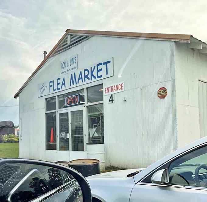 Uncle John's Flea Market exterior beckons with its no-nonsense charm. The white building practically whispers, "Come find your treasure!"