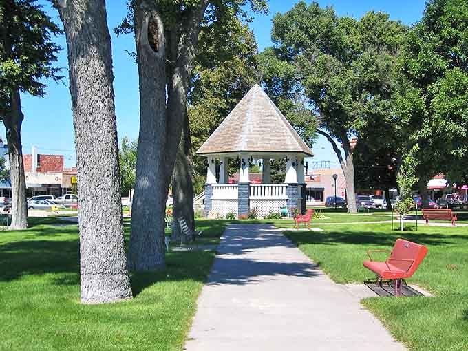 A charming gazebo sits peacefully in the park, inviting visitors to rest and watch the world drift by.
