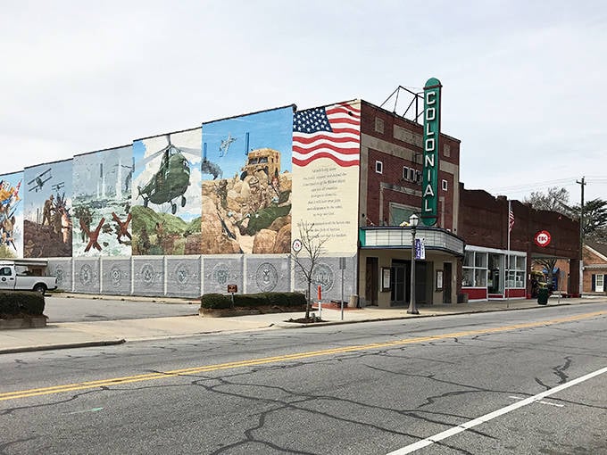 A patriotic mural celebrates local heroes alongside the historic Colonial Theatre&mdash;where movies cost less than your morning latte.