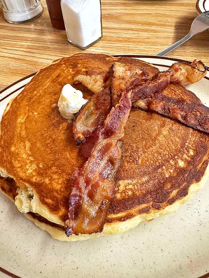 Pancakes so fluffy they need that bacon to anchor them to the plate. Breakfast doesn't get more honest than this.
